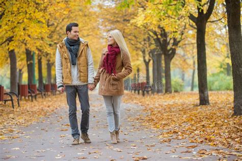 Couple Holding Hands While Walking In Park During Autumn Stock Image