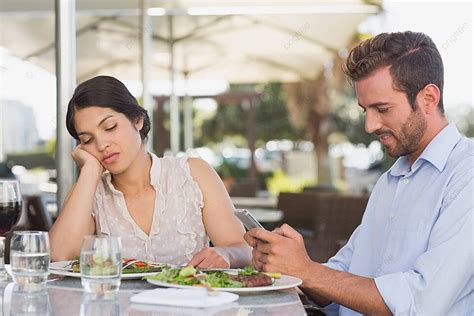 Bored Woman Being Ignored By Her Date Dialing Couple Together Photo