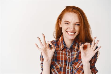 Premium Photo Sassy Redhead Girl Showing Okay Signs And Smiling Happy