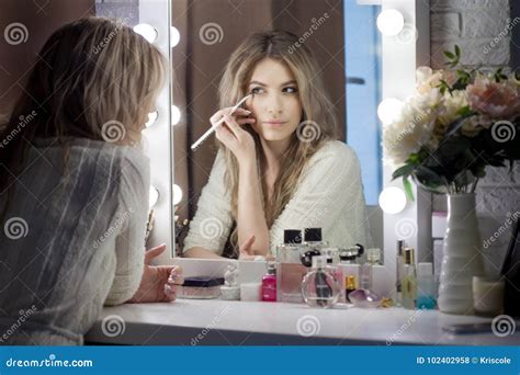 Amazing Young Woman Doing Her Makeup In Front Of Mirror Portrait Of