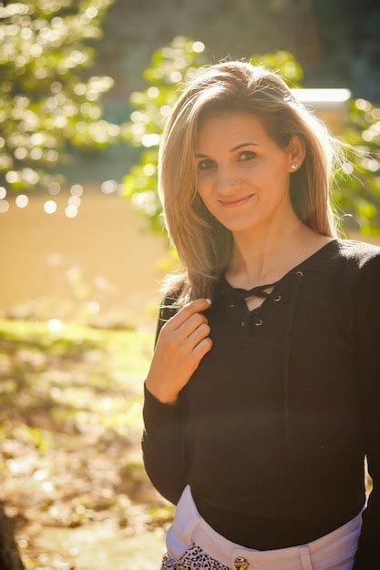 Premium Photo Portrait Of Beautiful Woman Standing At Park
