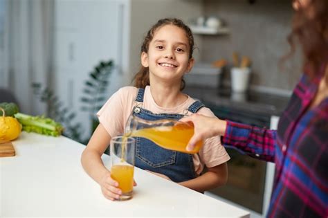 Premium Photo Portrait Of A Mom Pours Her Pretty Laughing Daughter