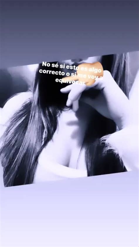 A Woman With Long Hair Holding Up A Cell Phone