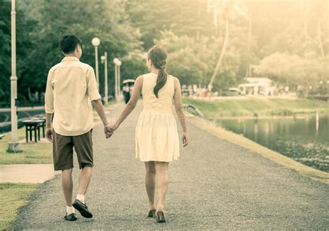 Young Couple In Love Holding Hand And Walking Together Stock Image