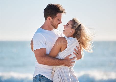 Love Beach Hug And Couple Smile Together At The Ocean For Peace Relax