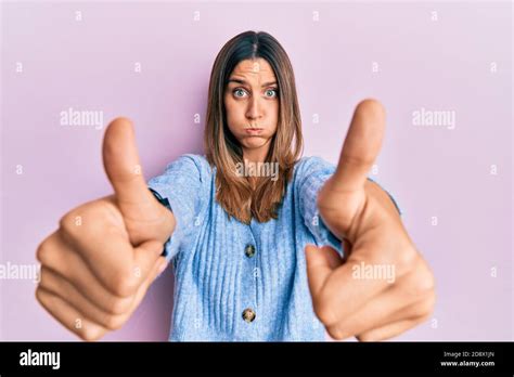 Brunette Young Woman Doing Thumbs Up Positive Gesture Puffing Cheeks
