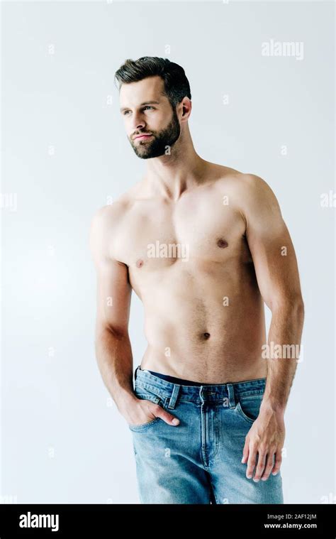 Shirtless Handsome Man In Jeans Posing With Hand In Pocket On Grey