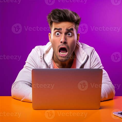 Surprised Man Looking At Laptop And Gesturing While Sitting At The Desk