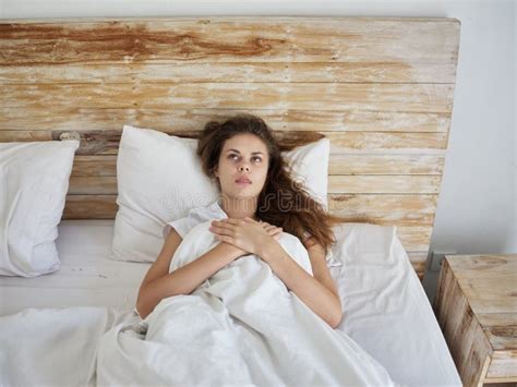 Woman Lying In Bed Under The Blanket Emotions Look Up Stock Image