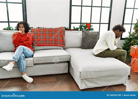 Young Interracial Couple On Problems With Sad Expression Sitting On The