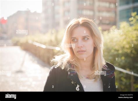 Young And Beautiful Caucasion Blonde Girl Walking Through The City At