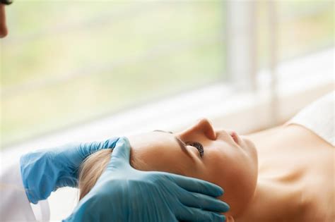 Premium Photo Young Woman Enjoying Of Facial Massage In Spa Salon