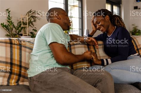 Caring Young Man Holding His Girlfriends Hand Consoling Her While She