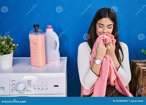 Young Beautiful Hispanic Woman Smiling Confident Smelling Clean Clothes