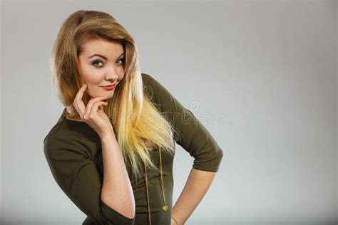 Attractive Blonde Woman Wearing Tight Green Khaki Top Stock Image