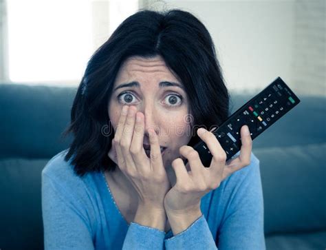Portrait Of A Young Woman Looking Scared And Shocked Watching Scary