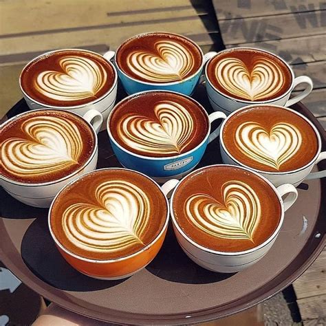 There Are Many Cups That Have Hearts In Them On The Tray And One Is