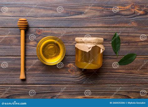 Honey Jar With Wooden Honey Dipper On White Background Top View With