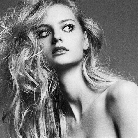 A Naked Woman With Long Hair Posing For The Camera