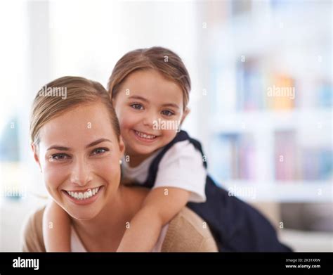Sweet Moments Portrait Of A Young Mother And Her Daughter Bonding At