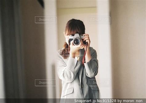 カメラにポーズ鏡の前に立っている女性の写真・画像素材[915328] Snapmart（スナップマート）