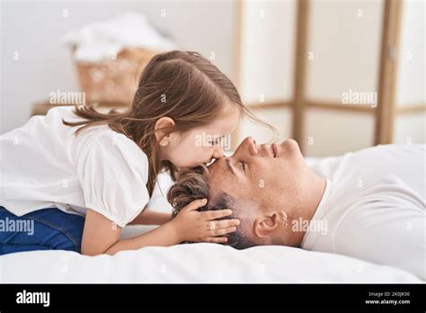 Father And Daughter Father And Daughter Kissing On Head At Bedroom