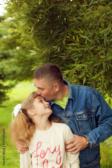 Father And Teen Daughter Hugging