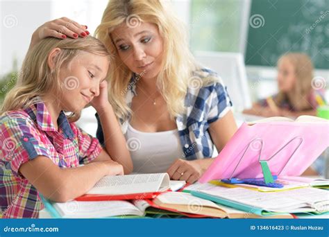 Portrait Of Cute Teacher With Two Schoolgirls During Lesson Stock Image