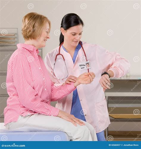 Female Doctor Checking Womans Pulse During Check Stock Image Image Of