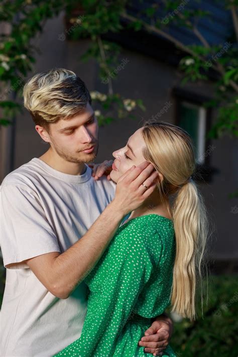 Premium Photo A Man Hugged His Girlfriend And Holding His Hand To Her