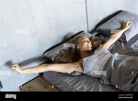 Young Beautiful Woman Waking Up In Her Bed Fully Rested Woman