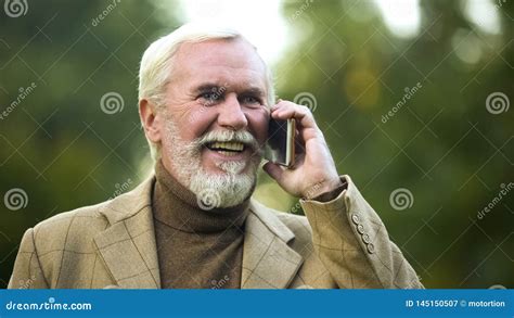 Happy Senior Man Talking On Phone In Park Mobile Communication
