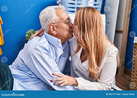 Middle Age Man And Woman Couple Hugging Each Other And Kissing Waiting