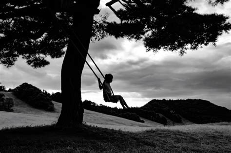 Premium Photo Side View Of Silhouette Girl Swinging Against Cloudy Sky