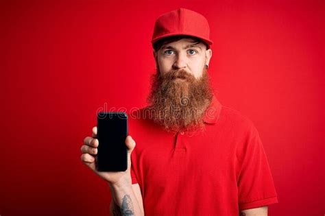 Redhead Irish Delivery Man With Beard Holding Smartphone Showing App On