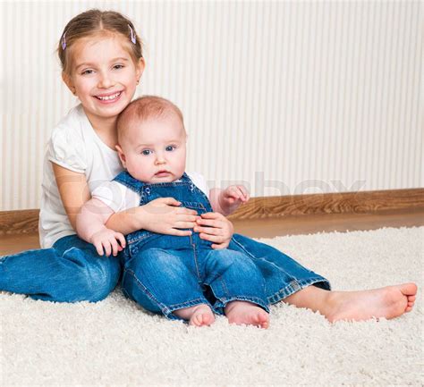 Two Sisters Sitting On The Floor Stock Image Colourbox