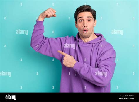 Photo Of Strong Impressed Young Guy Dressed Violet Sweatshirt Pointing