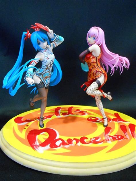 Two Anime Figurines Are Posed On A Plate