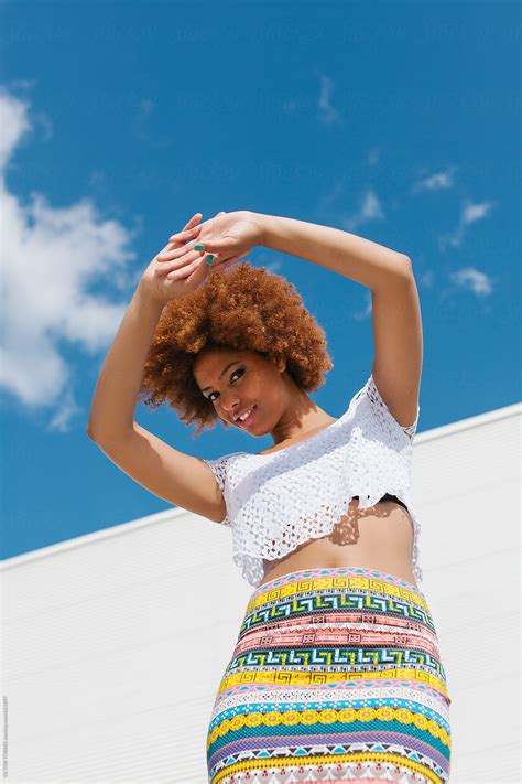 Latin American Afro Woman In A Radiant Summer Day By Stocksy