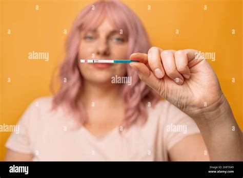 Happy Young 30s Woman Holds A Positive Pregnancy Test In Her Hand