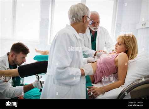 In The Hospital Woman In Labor Pushes To Give Birth Obstetricians