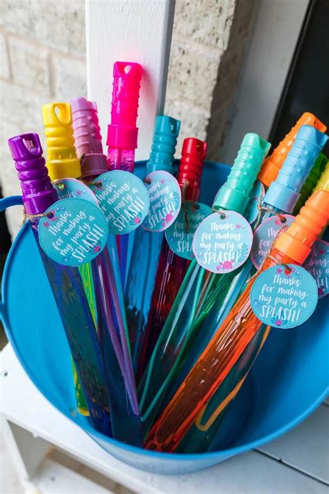 A Bucket Filled With Lots Of Different Colored Straws And Paper Tags On