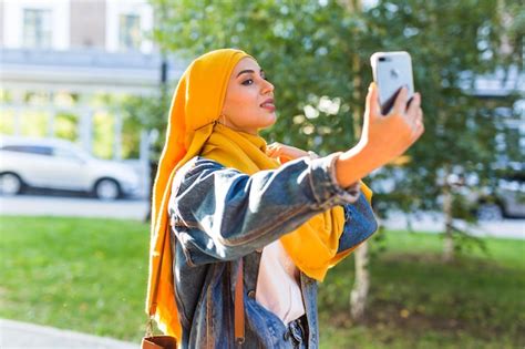 Premium Photo Muslim Girl In Hijab Makes A Selfie On The Phone