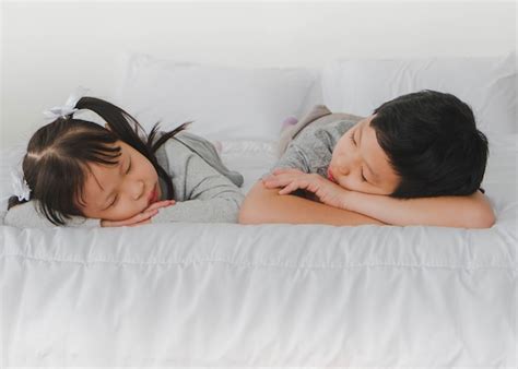 Premium Photo Asian Sister Sleeping With His Brother In White Bedroom