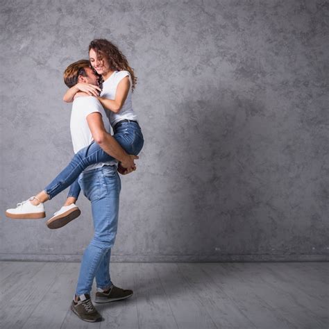 Free Photo Man Holding Woman In Arms