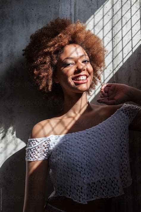 Latin American Afro Woman In A Dark Urban Setting By Stocksy