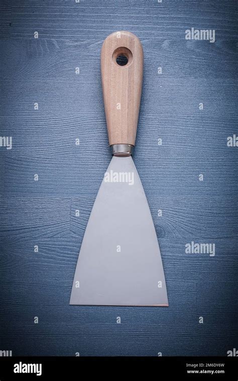 single paint scraper with wooden handle Stock Photo - Alamy