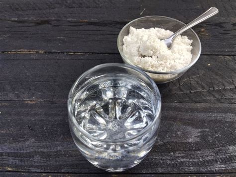 Warm Salt Water Solution on the Black Wood Stock Photo - Image of ...