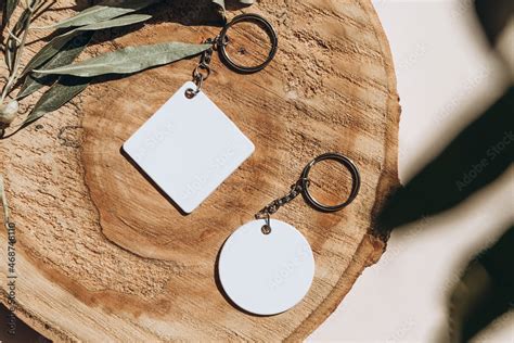 Keychain mockup among olive leaves to display design. Blank white ...