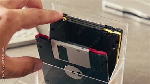 Floppy disc FDD close up, Using diskette for old PC computer macro. Archive programme or Music recorder, playing retro computer games. Vintage device for office, obsolete technology.